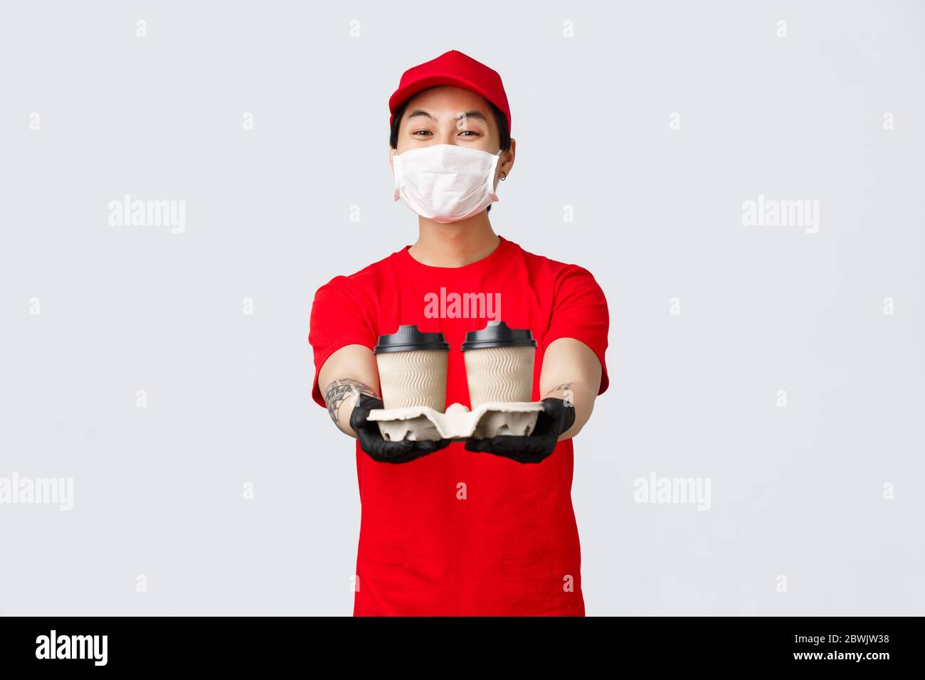 Friendly smiling asian delivery man working during covid 19 pandemic ...