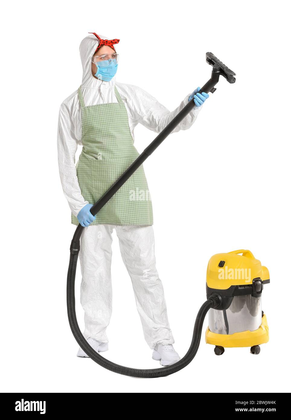 Housewife in protective costume and with vacuum cleaner on white ...