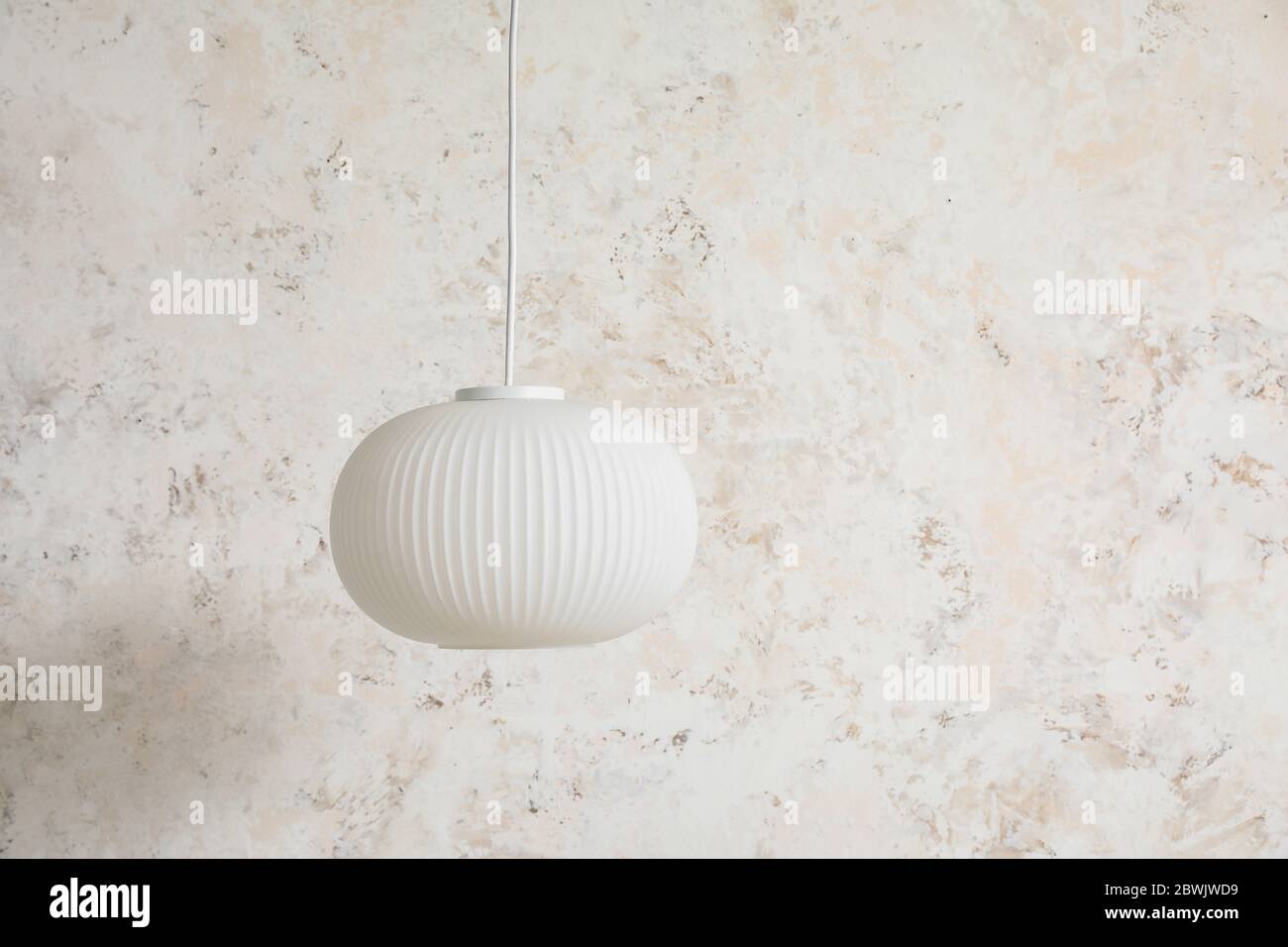 Modern lamp against light wall Stock Photo - Alamy