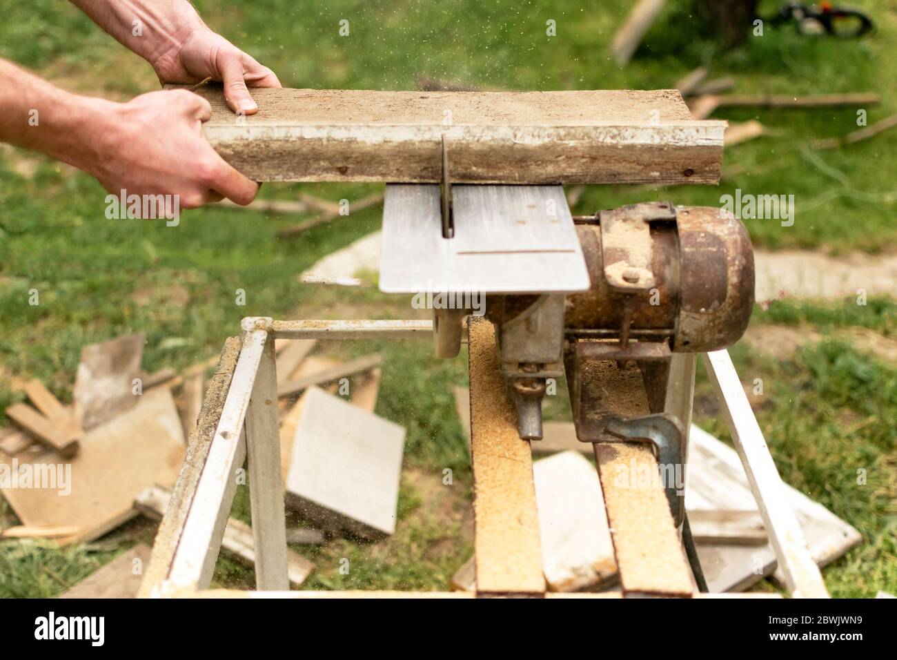 Construction contractor worker using a worm-driven hand-held circular ...