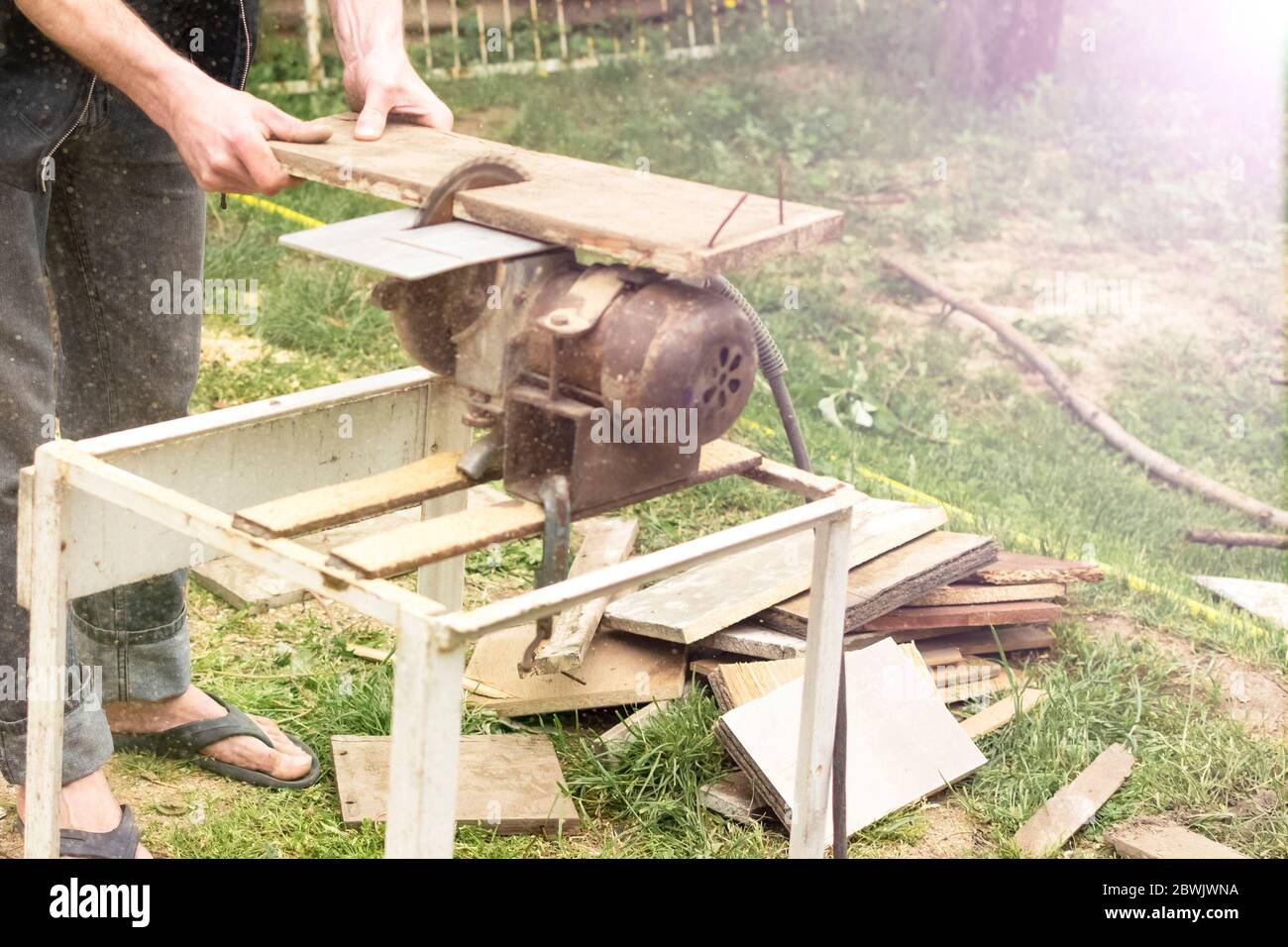 Construction contractor worker using a worm-driven hand-held circular ...