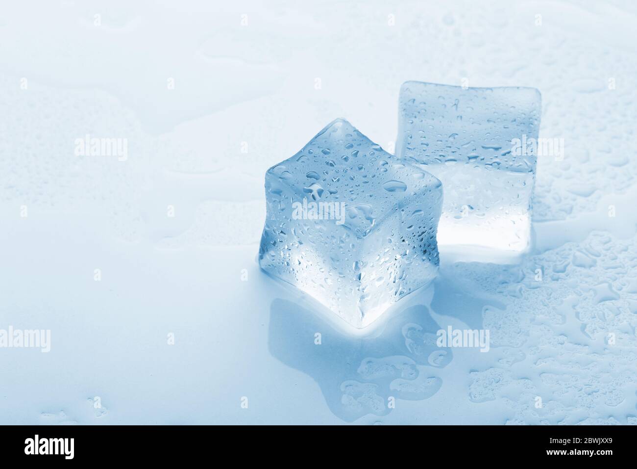 Melted ice cubes close up isolated on white background Stock Photo - Alamy