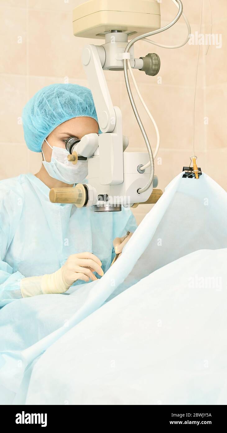 Ophthalmology laser microscope operation. Doctor in clinic. Patient eye ...