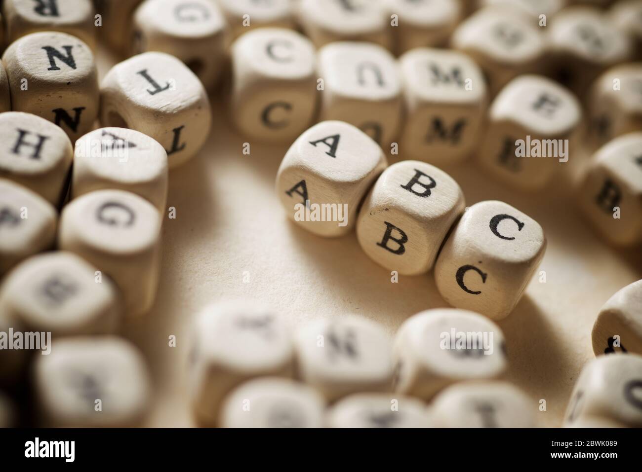 Letter cubes on a brown paper Stock Photo - Alamy