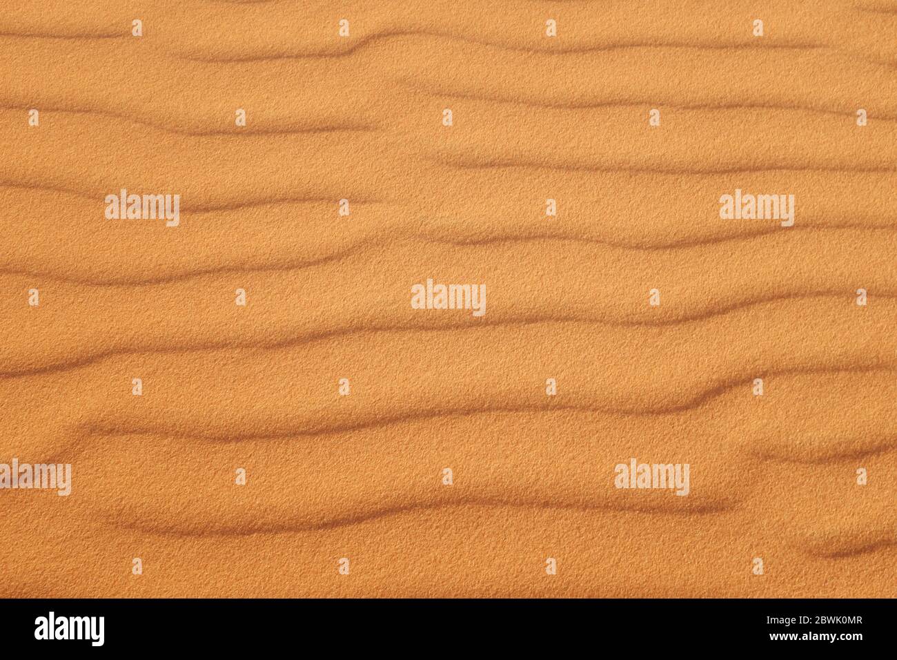 Bright orange desert sand pattern ripples for a warm summer background ...
