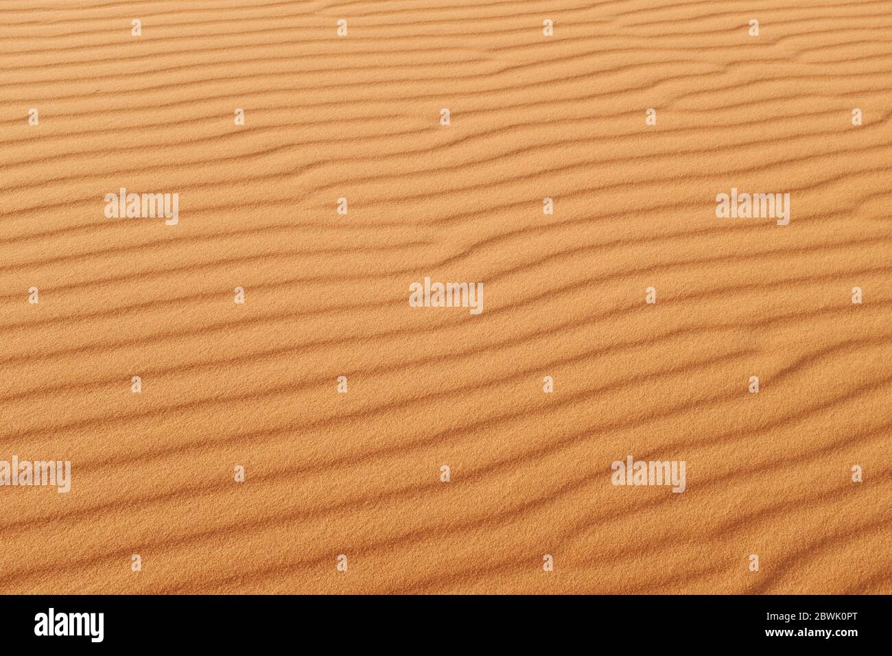 Bright orange desert sand pattern ripples for a warm summer background ...