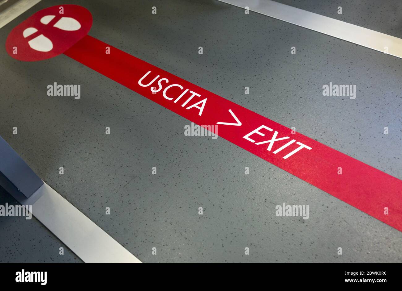 Exit sign painted on the floor of the metro - italian and english ...
