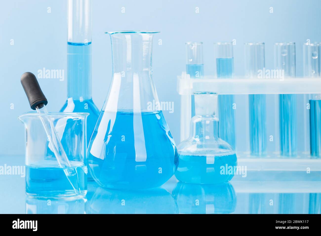 Laboratory glassware with a pipette and test tubes. scientific ...