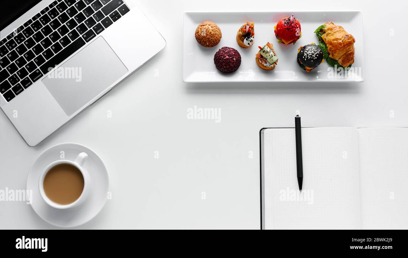 Flat lay photo of office desk with laptop, phone, headphones, notepad ...