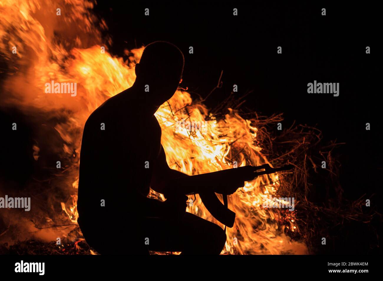 black guy on a background of fire with a gun Stock Photo - Alamy