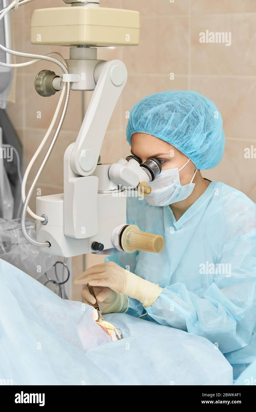 Ophthalmology laser microscope operation. Doctor in clinic. Patient eye ...
