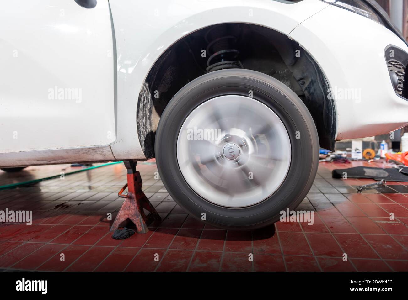 Car mechanic testing the brake on car wheel on the garage Stock Photo ...