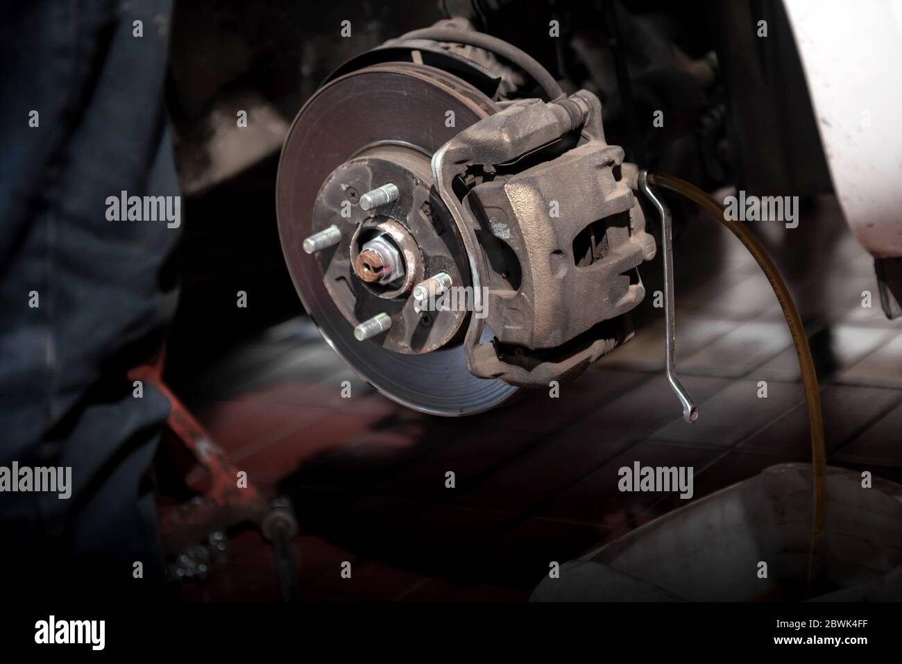 Car mechanic change the car wheel brake oil on the garage Stock Photo ...