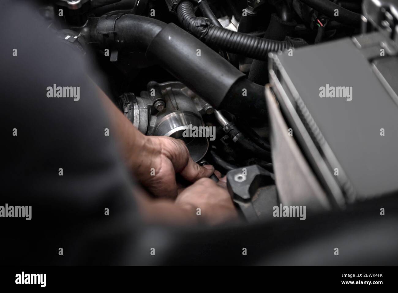 Car mechanic working on engine repair on the garage Stock Photo - Alamy