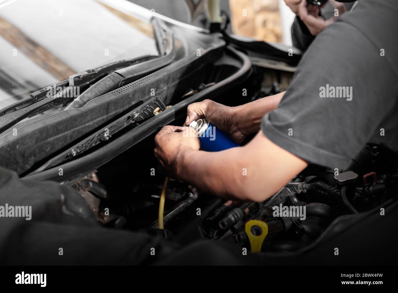 Car mechanic working on engine repair on the garage Stock Photo - Alamy