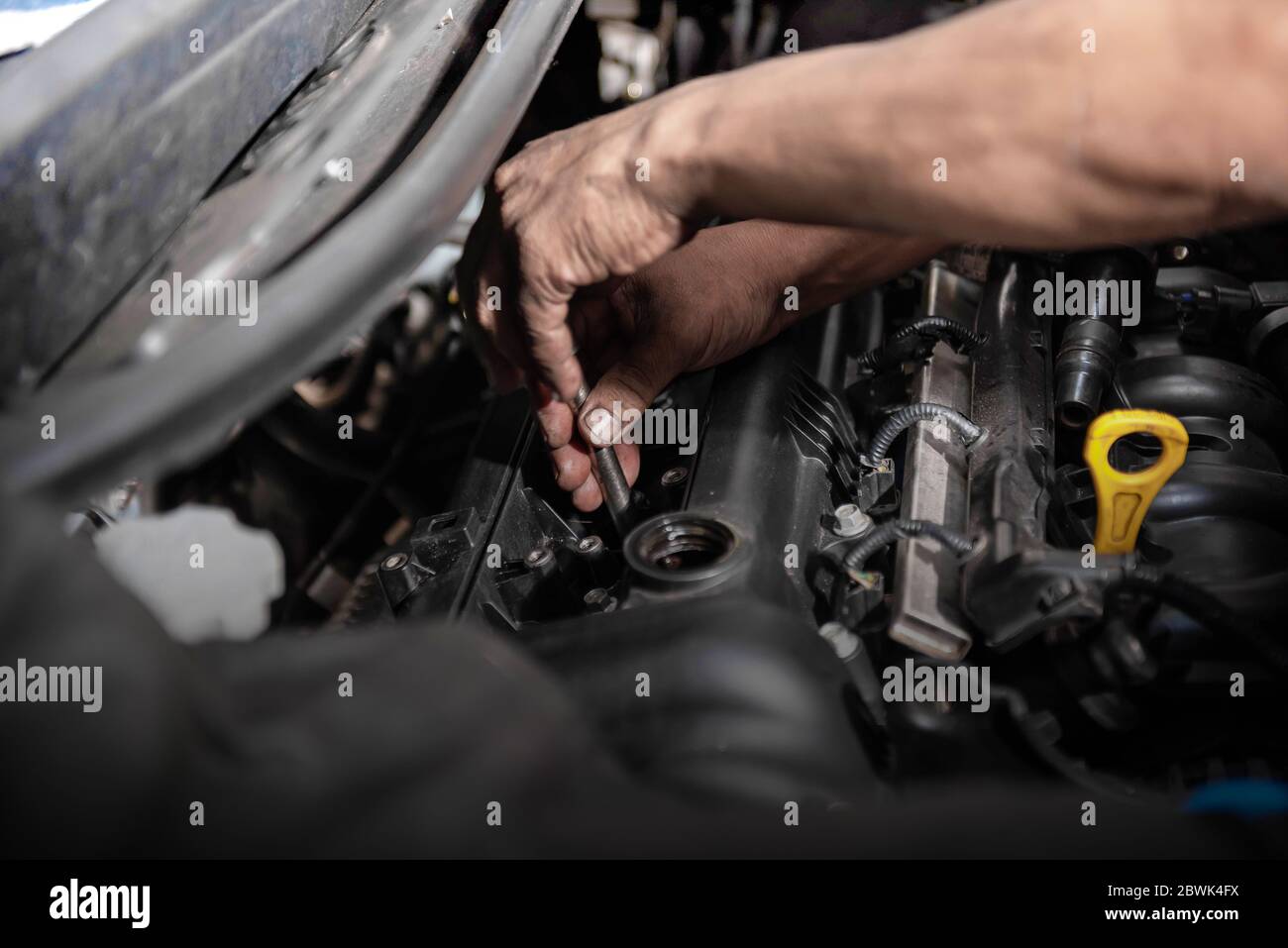 Car mechanic working on engine repair on the garage Stock Photo - Alamy