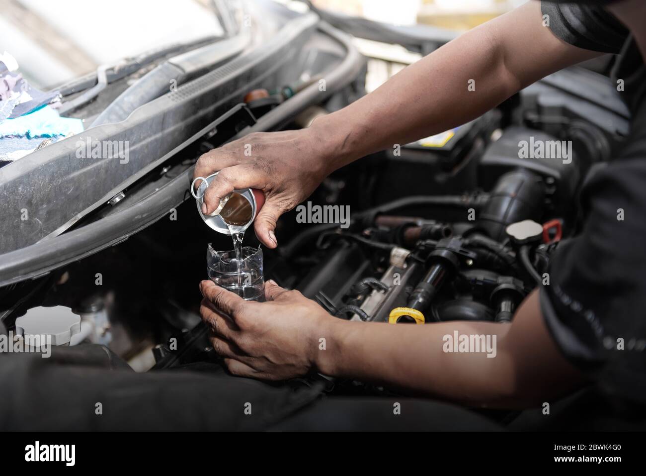 Car mechanic working on engine repair on the garage Stock Photo - Alamy