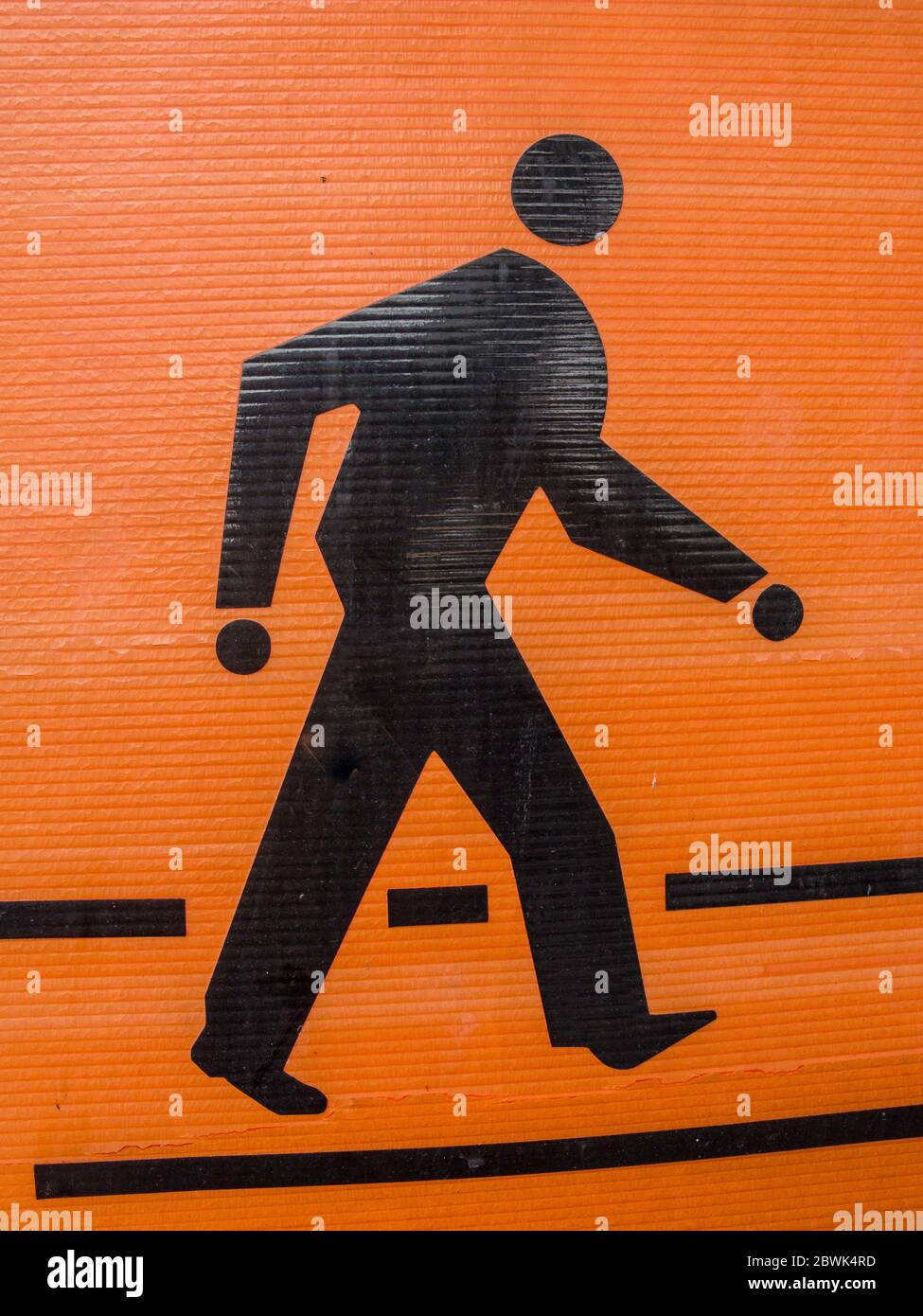 The orange-black pedestrian symbol Stock Photo - Alamy