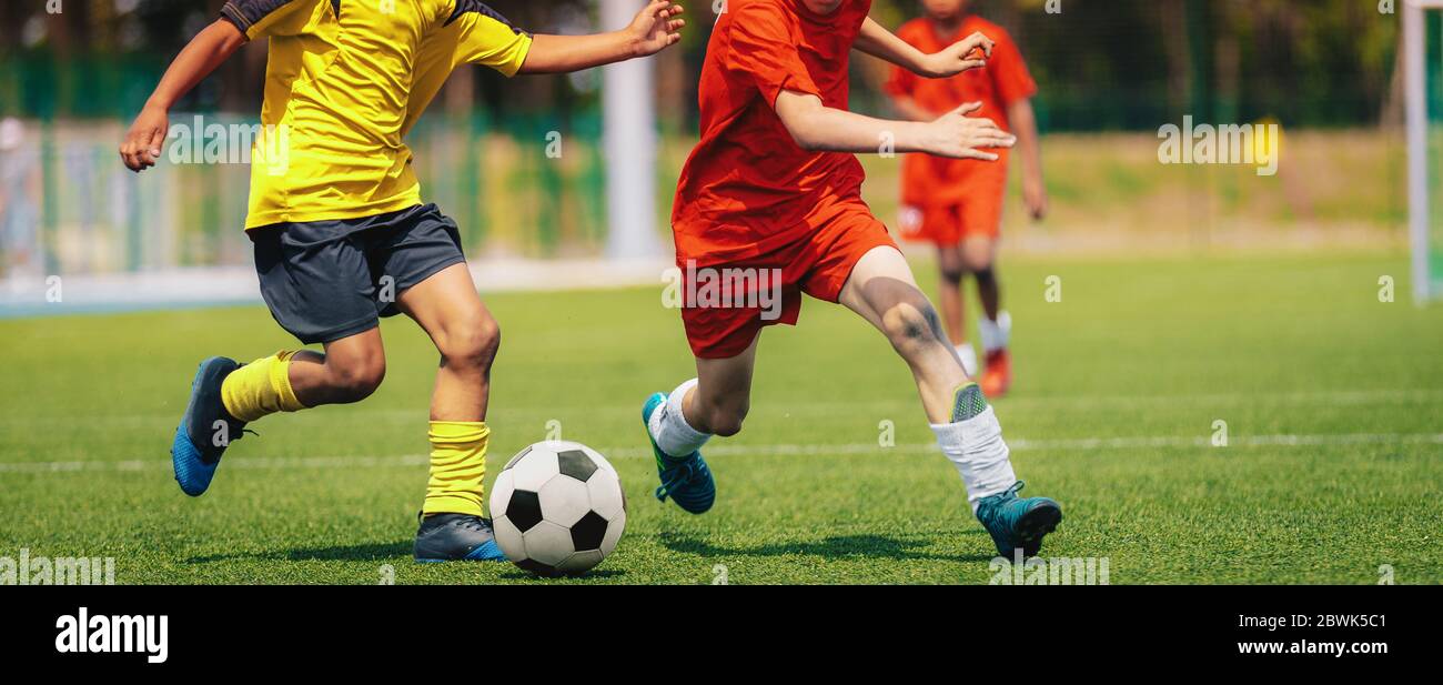 Sporty Football Boys Running After Ball in Duel. School Soccer ... Sporty Football Boys Running After Ball in Duel. School Soccer ...