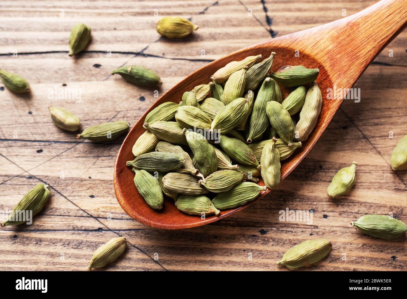 Whole grains of cardamom, a stick of cinnamon star anise and cane sugar ...