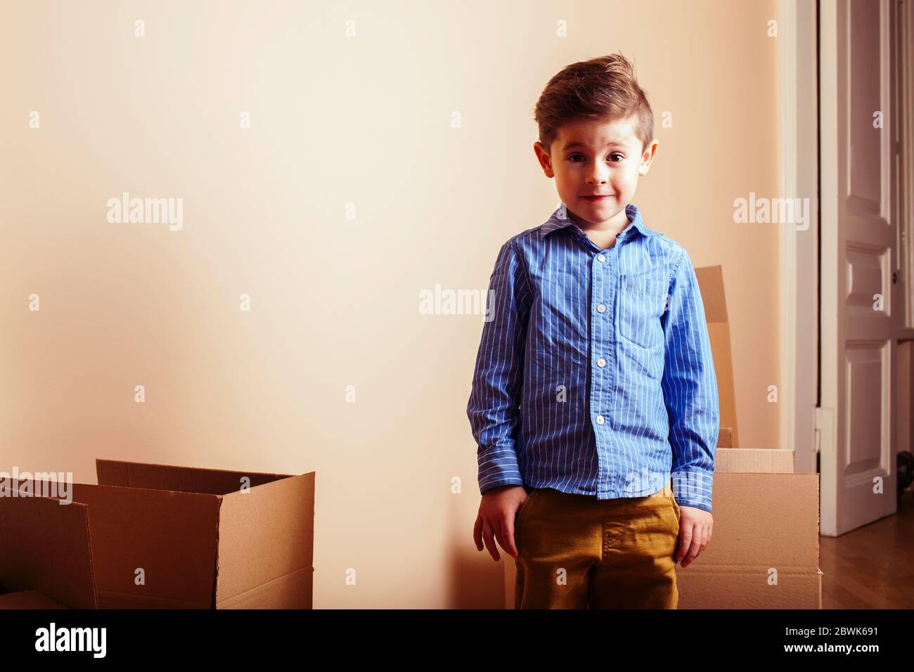 little cute boy in empty room, move to new house. home alone among ...