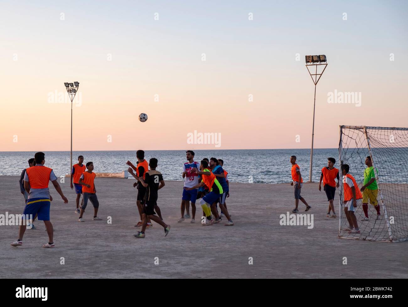 Young men playing football near the beach in Al Ghubra suburb, Muscat ...