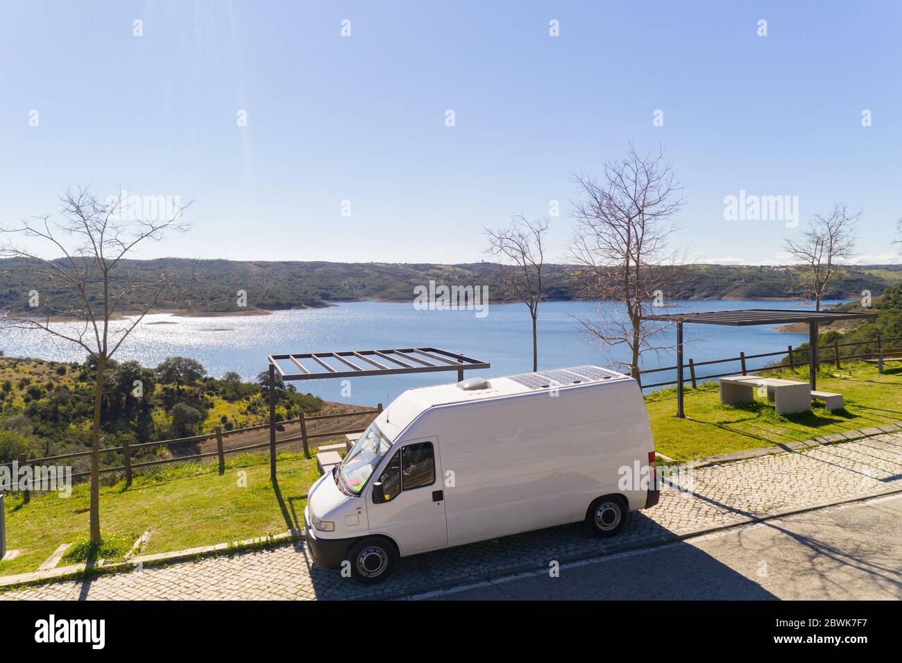 Camper van with solar panel drone aerial view in Odeleite dam reservoir ...