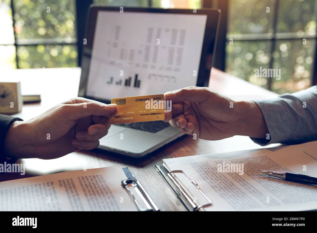 The bank clerk is talking to a customer who applied for a credit card ...