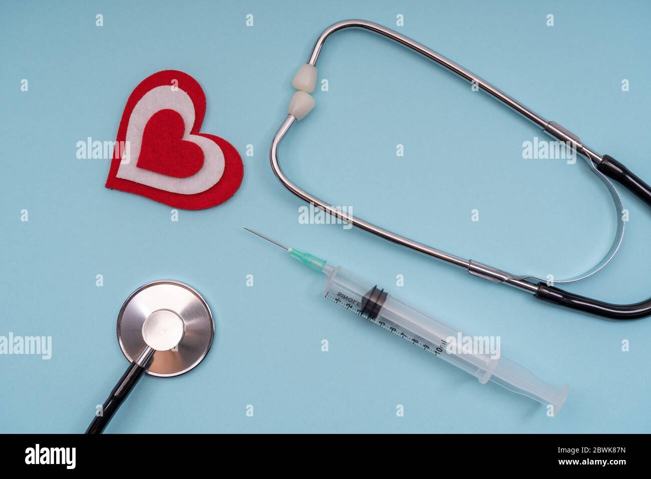 Medical tools stethoscope, syringes with a heart on a blue background ...