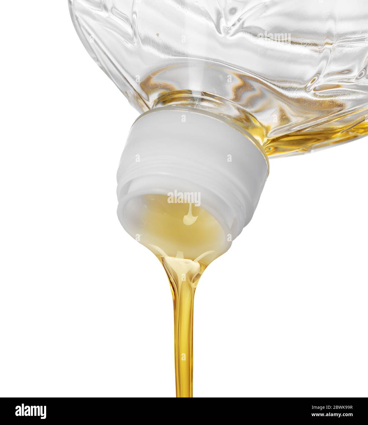 Pouring oil for cooking in a bottle isolated on white background Stock ...