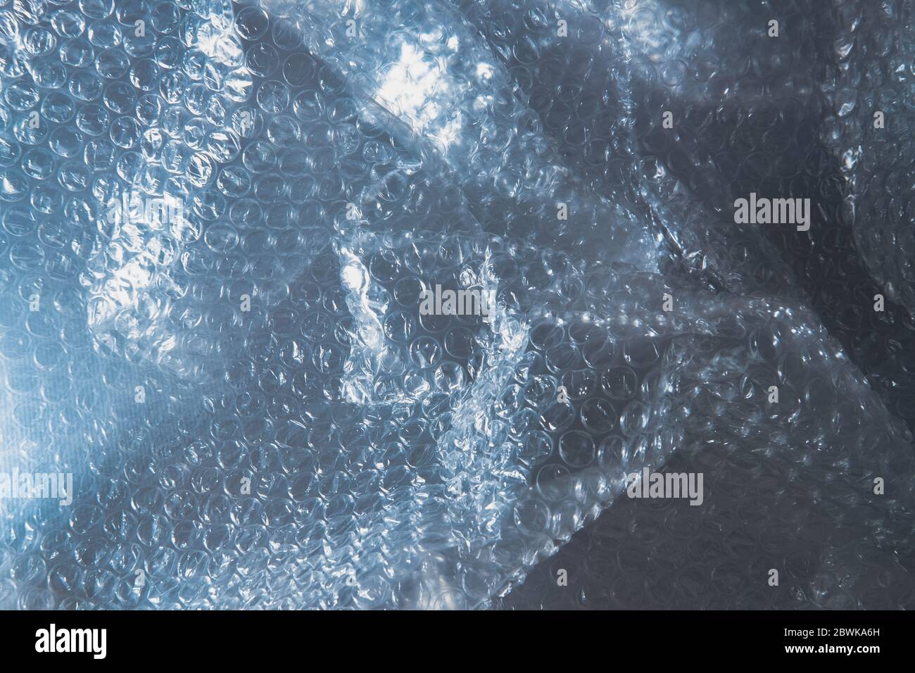 Plastic bubble wrap texture. Backdrop of blue bubble package, shot in low key Stock Photo - Alamy