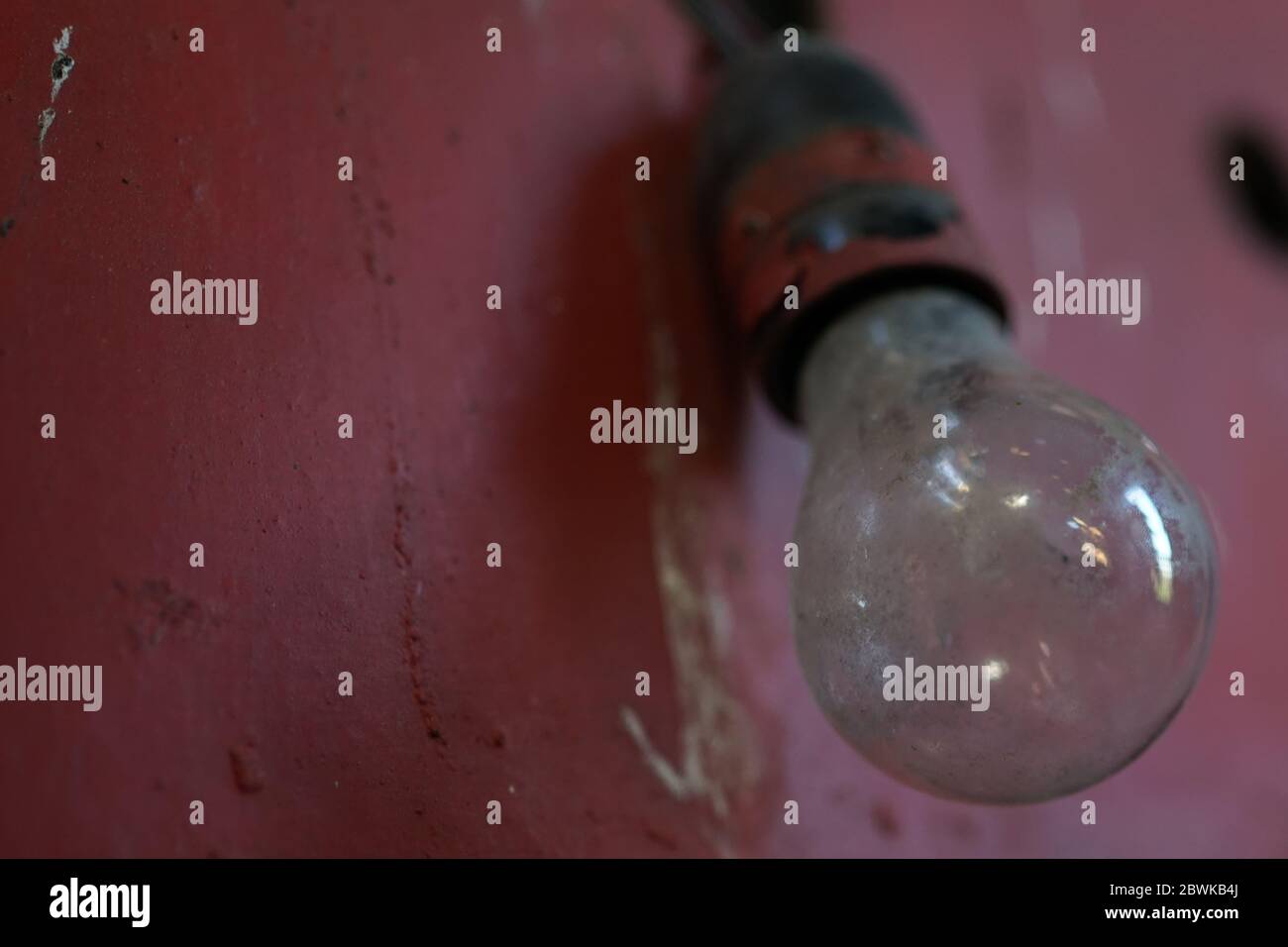 Rusty dusty red antique vintage lightbulb on old advertisement sheet ...