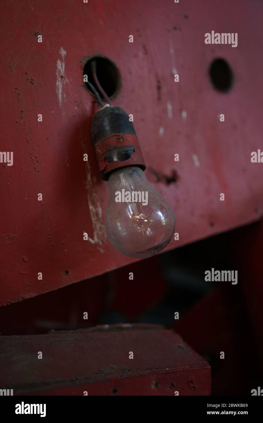 Rusty dusty red antique vintage lightbulb on old advertisement sheet ...