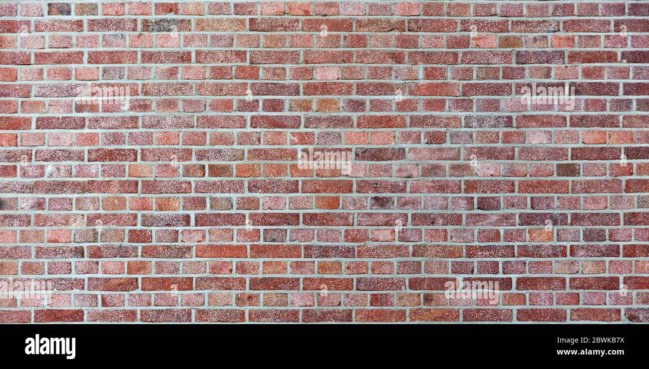 Red brick wall as a wall background texture header Stock Photo - Alamy