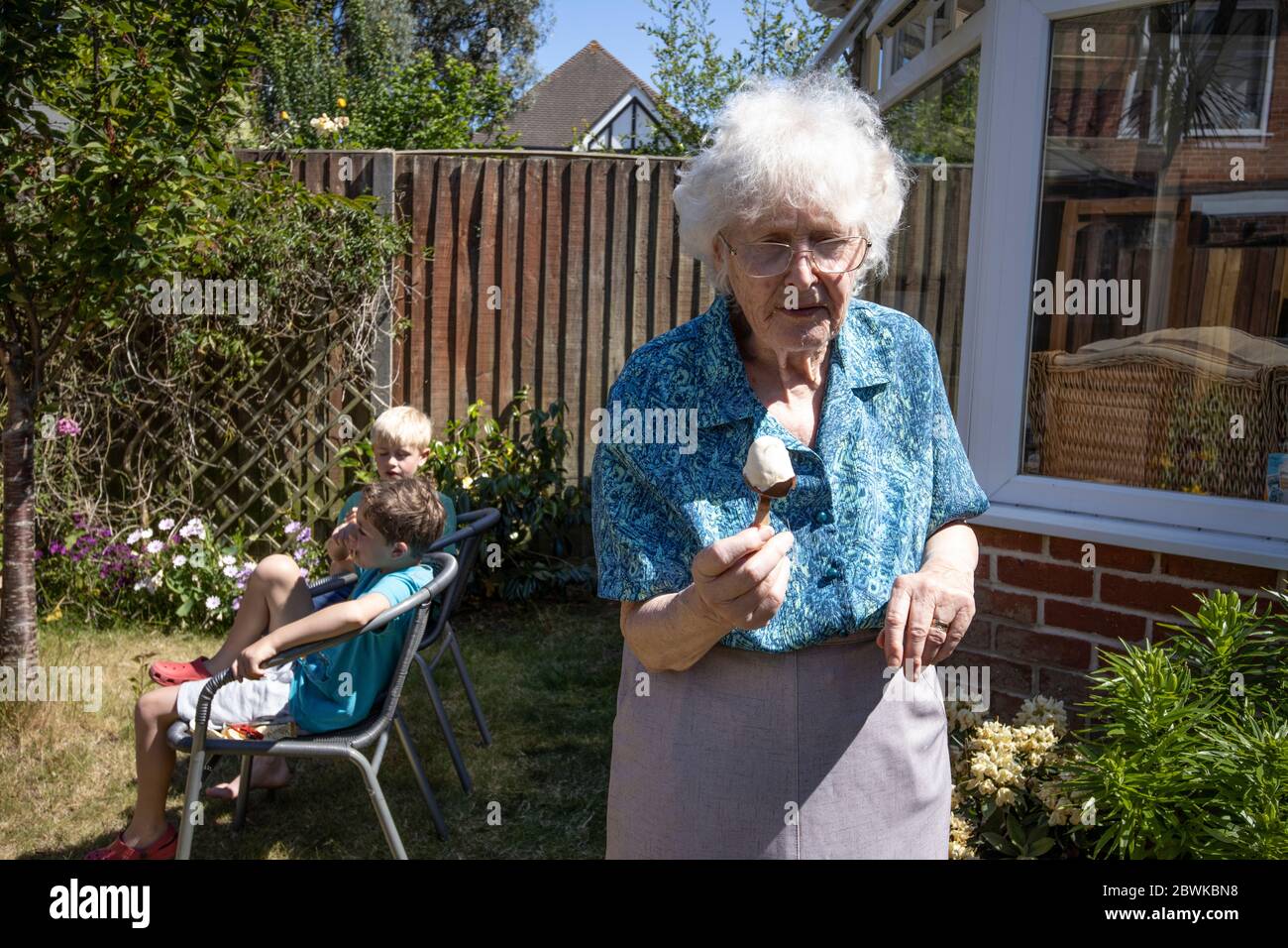Elderly woman in her 80's, with her grandsons enjoying the sunny ...