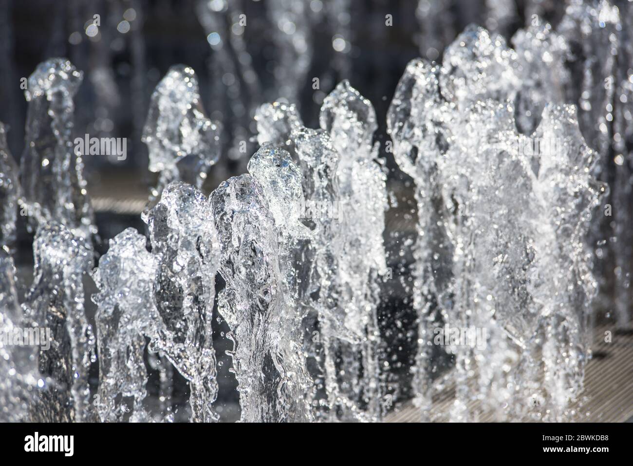 Close-up of small splashing dancing fountains Stock Photo - Alamy