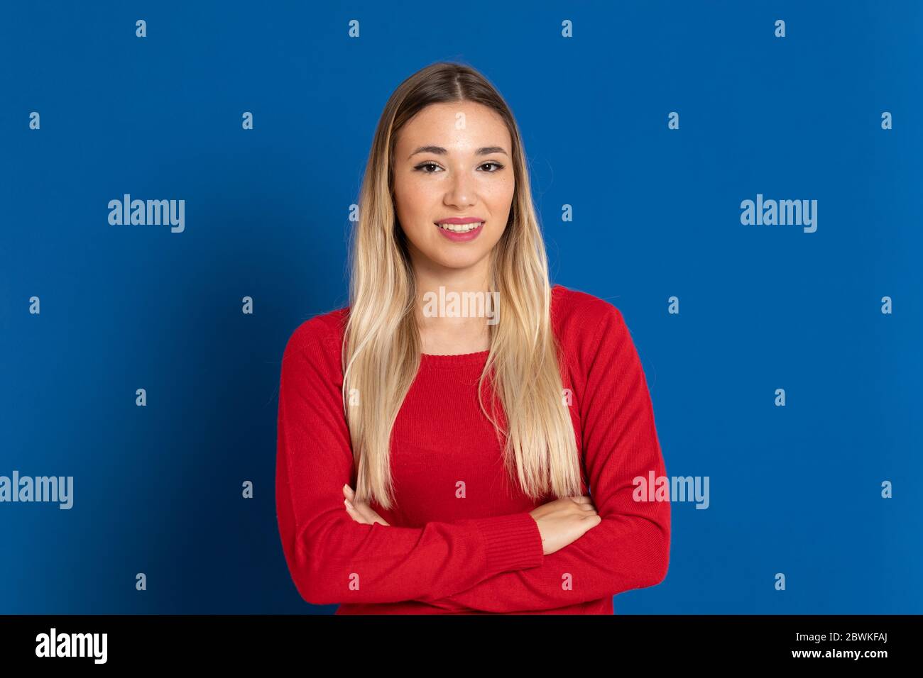 Fair girl with red T-shirt on a blue background Stock Photo - Alamy
