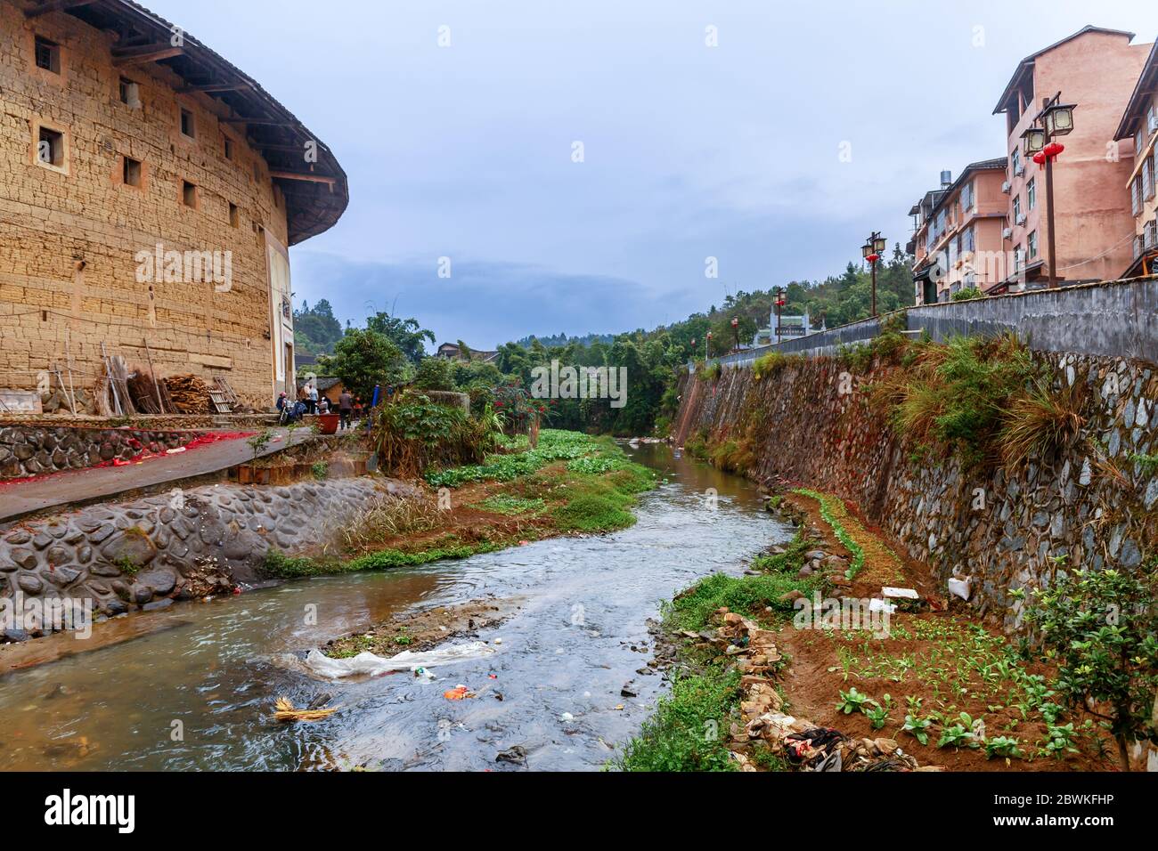 Panorama of Fujian landscape: A traditional tulou ("earthen house") and ...