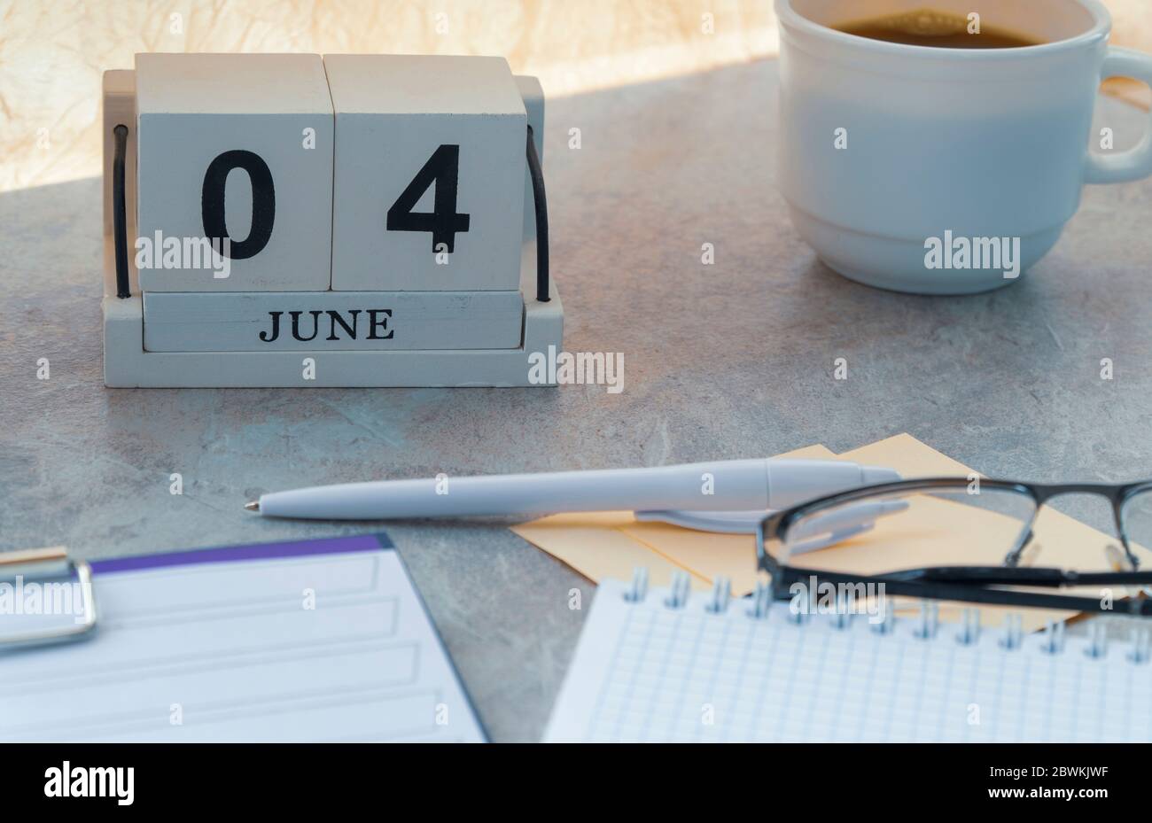 June 04, date on the calendar. Handmade wood cube with date month and ...