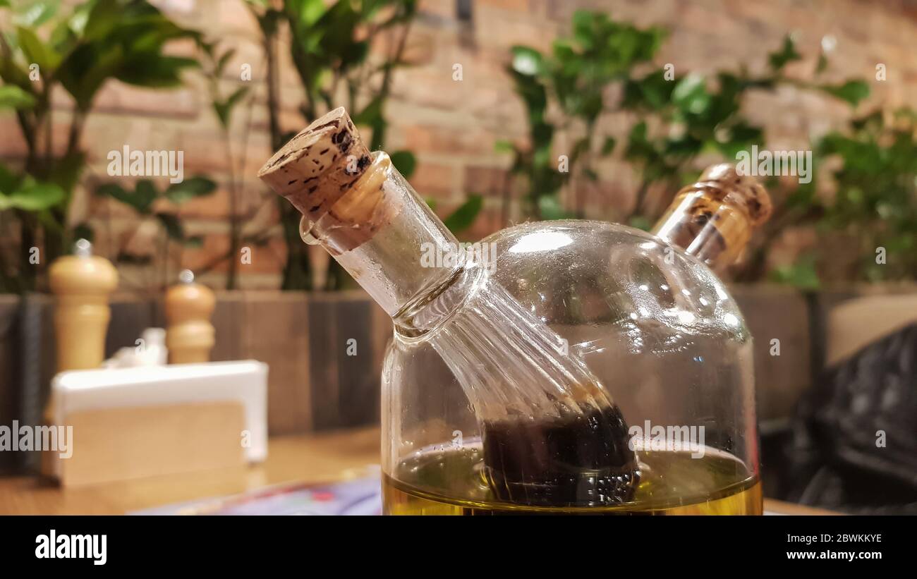 Glass bottle with sauce and butter for pizza and pasta, standing on a ...