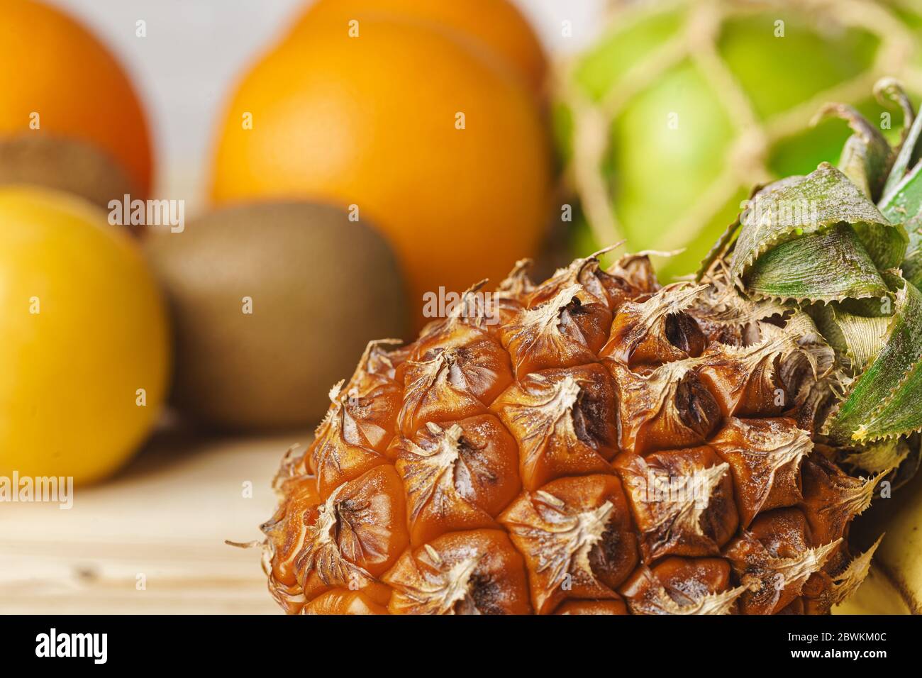 Pineapple, green apples and apricot on table Stock Photo - Alamy