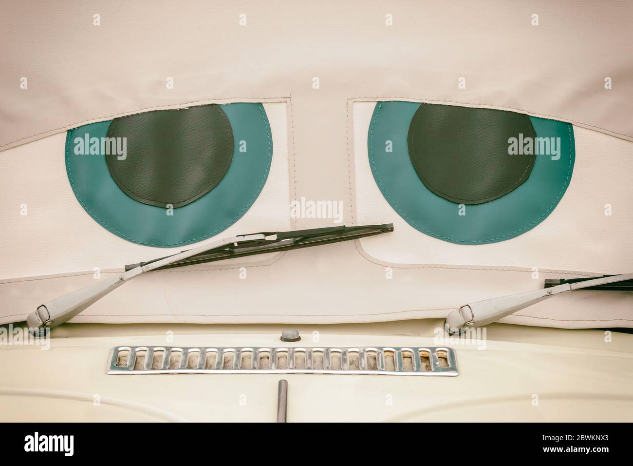 Cute front view of a classic car covered with a hood with eyes Stock ...