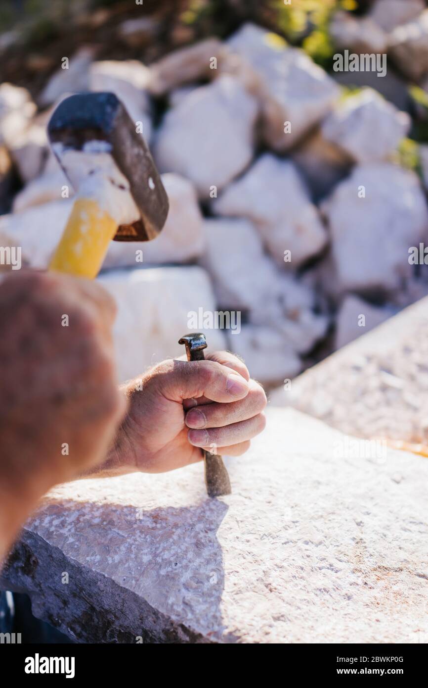 Stone carver working with hammer and chisel Stock Photo - Alamy