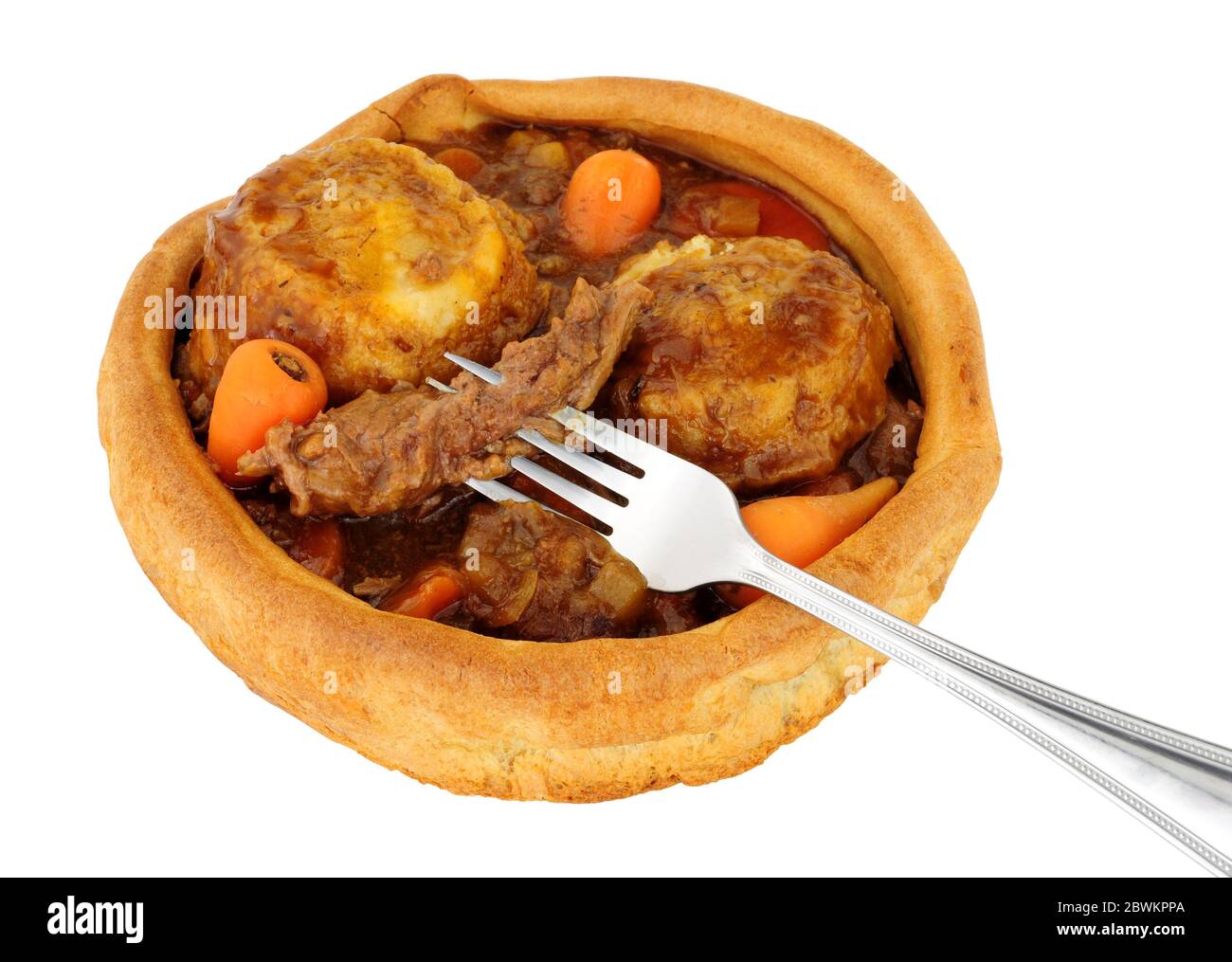 Beef and vegetable stew with dumplings in a large Yorkshire pudding ...