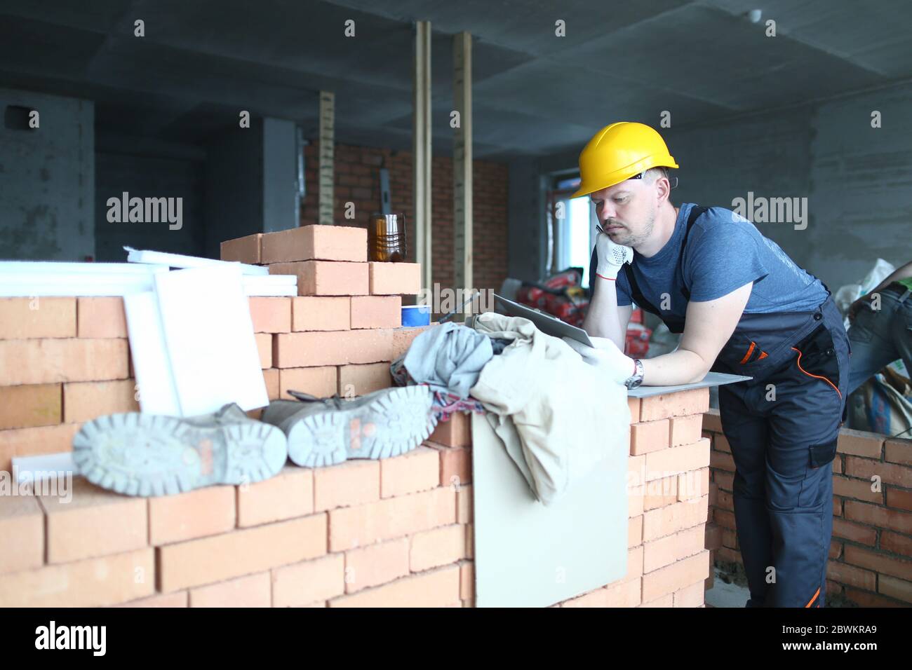 Concentrated young builder creating plan of action Stock Photo - Alamy