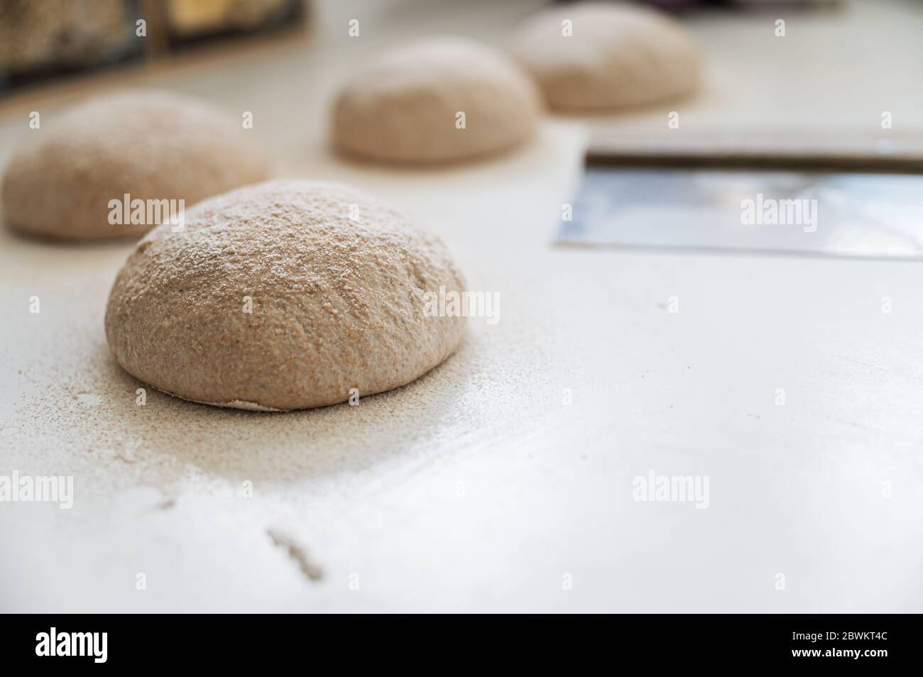 Fresh sourdough dough for bread buns resting and rising on kitchen ...