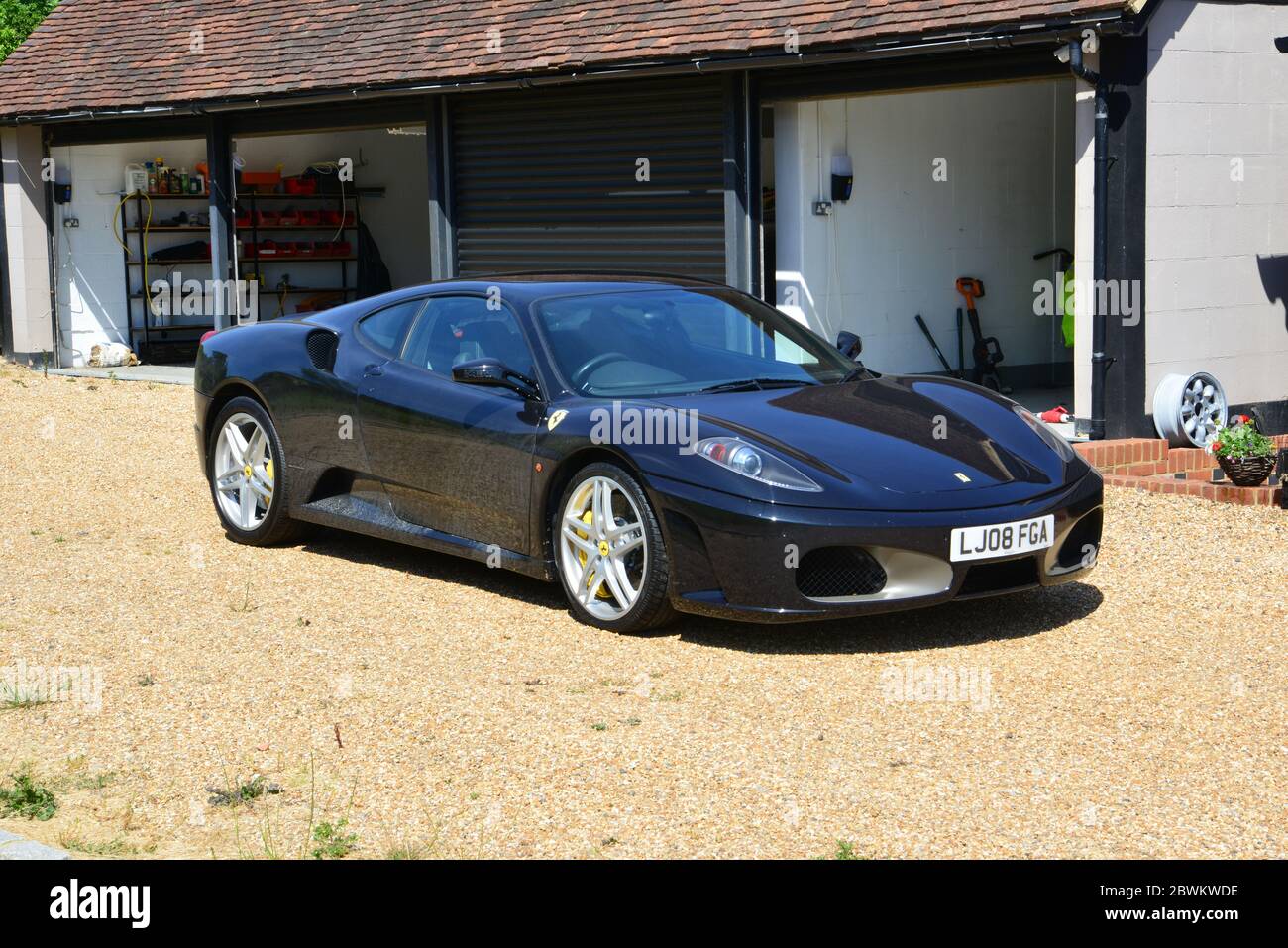 A black Ferrari parked in a courtyard Stock Photo - Alamy