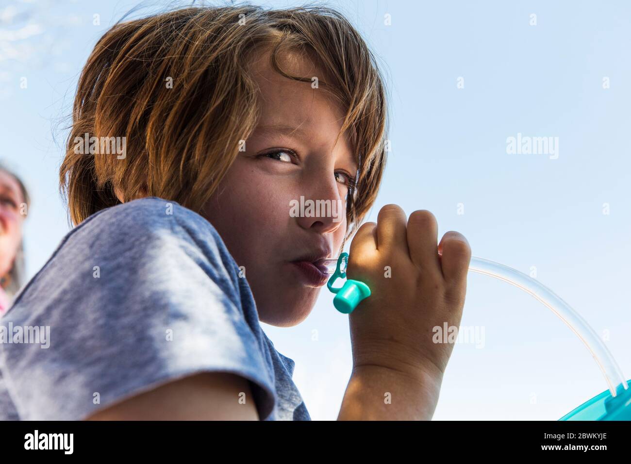 6 year old boy sipping water from hydration bladder Stock Photo - Alamy