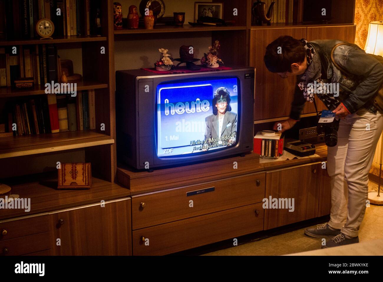 A visitor looks at a reconstruction of a typical GDR-era living room in ...