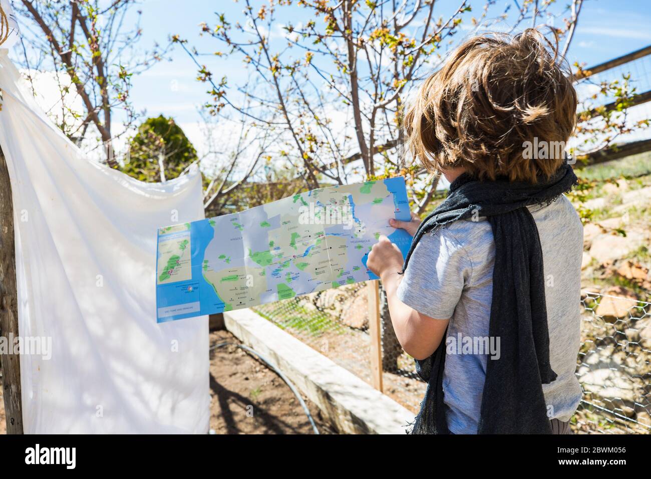 Six year old boy playing on make believe sailing ship with a large ...